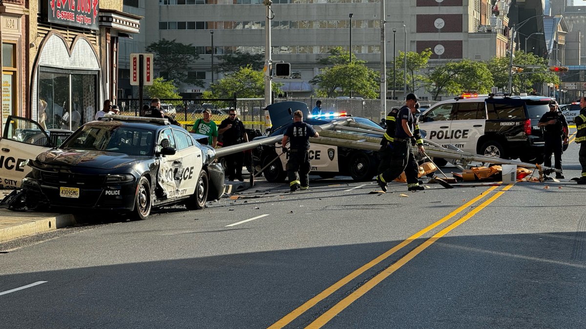 Crash at Jersey Shore brings down red light, damages police cars ...