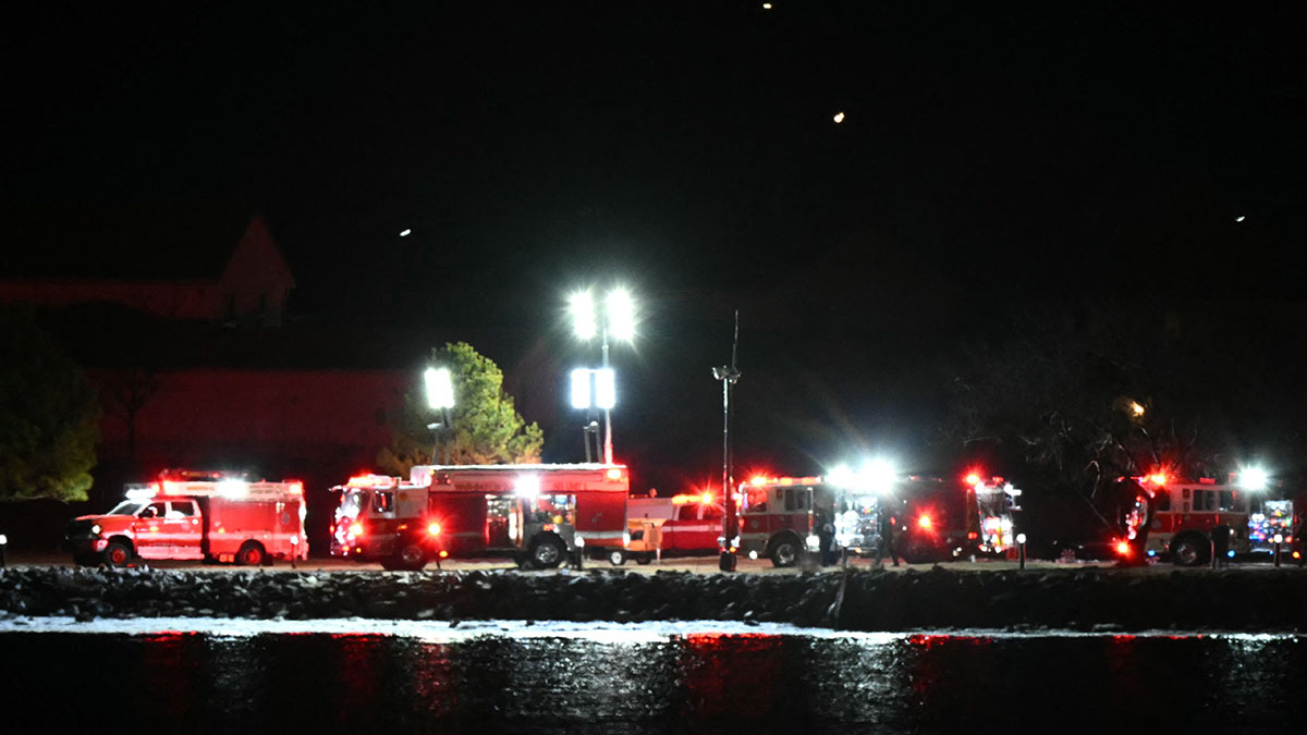 Photos: Massive response to crash of commercial jet, helicopter into ...