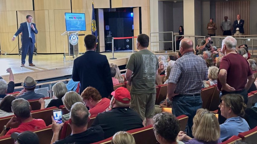 Rep. Mike Flood speaks and takes questions during a town hall meeting on the University of Nebraska campus, Monday, Aug. 4, 2025 in Lincoln, Neb. The second-term Republican braved a Democratic-heavy audience of roughly 700, most of whom booed and chanted in opposition to the GOP-backed tax-break and spending-cut bill President Donald Trump signed last month.
